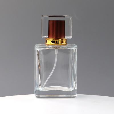 China Square Transparent Glass Perfume Bottle with Acrylic Cover - 50ml/100ml Capacity, Customizable OEM Options for sale