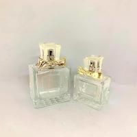 China 50ml 100ml Empty Glass Perfume Bottle with Alloy Bow Spray Custom OEM for sale