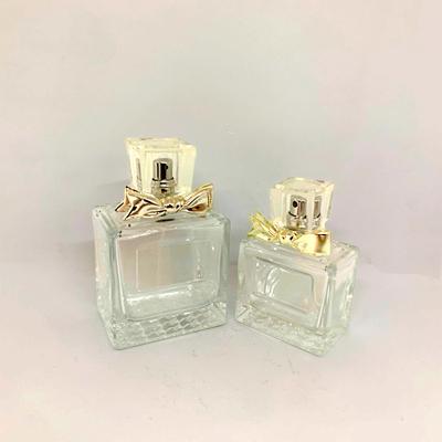 China 50ml 100ml Empty Glass Perfume Bottle with Alloy Bow Spray Custom OEM for sale