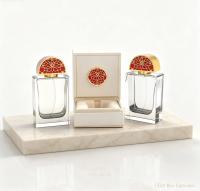 China Semicircle Hollow Floral Zamac Perfume Cap with Red Enamel Gold Plated Finish and Custom Logo Engraving for sale