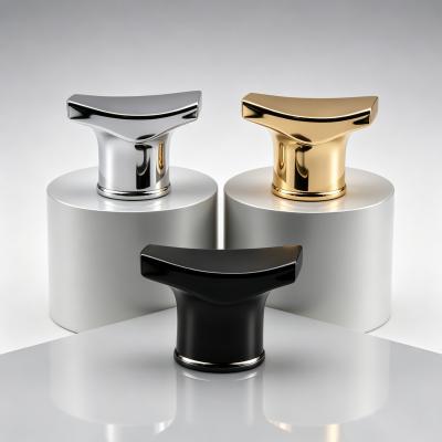 China Luxury Curved Wing‑Shape Zinc Alloy Perfume Cap Flared Zamac Lid Mirror Electroplating Custom Logo OEM for sale
