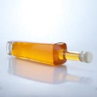 China 700ml High Flint Round Shape Liquor Glass Bottle with Custom Logo and Cork Top Finish for sale