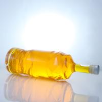 China Liquor Glass Bottle with Embossed Customizable Logo and Clear or Customized Bottle Color for sale
