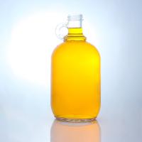 China Customized Logo Round Shape Liquor Glass Bottle with Handle and Screw Cap for sale