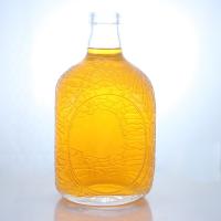 China Unique Round Shape Embossed Food Grade Rum Vodka Whisky Tequila Gin Glass Bottle with Cork Perfect for sale