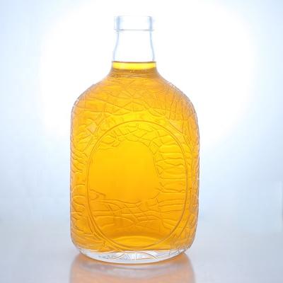 China Unique Round Shape Embossed Food Grade Rum Vodka Whisky Tequila Gin Glass Bottle with Cork Perfect for sale