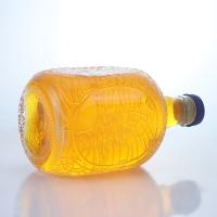 China Unique Round Shape Embossed Food Grade Rum Vodka Whisky Tequila Gin Glass Bottle with Cork Perfect for sale