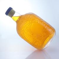 China Unique Round Shape Embossed Food Grade Rum Vodka Whisky Tequila Gin Glass Bottle with Cork Perfect for sale