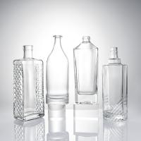 China Clear Glass Liquor Bottle with Embossed Body and Cork Stopper for sale