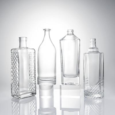 China Clear Glass Liquor Bottle with Embossed Body and Cork Stopper for sale