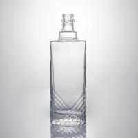 China Clear Glass Liquor Bottle with Embossed Body and Cork Stopper for sale