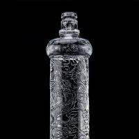 China Beautiful Dragon Embossed Glass Bottle With Golden Lid Customized Logo and Glass Base for sale