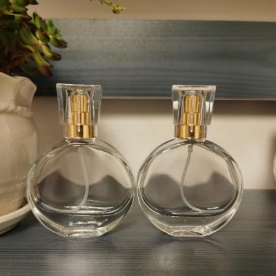 China Smooth Surface Oblate Glass Perfume Bottle 30ml 50ml 100ml for sale
