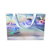China boutique Custom Printed Paper Bags Holographic Shopping Bag With Ribbon Handle for sale