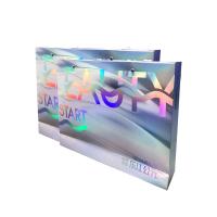 China boutique Custom Printed Paper Bags Holographic Shopping Bag With Ribbon Handle for sale