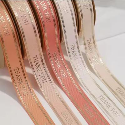 China Customized Polyester Gold Foil Branded Ribbon with 3D Logo for Christmas and Birthday for sale