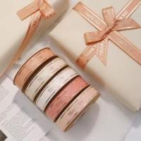 China Customized Polyester Gold Foil Branded Ribbon with 3D Logo for Christmas and Birthday for sale