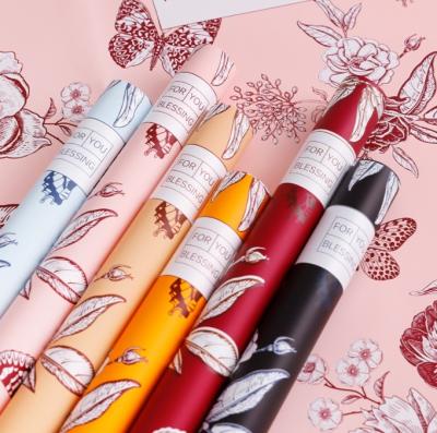 China New butterfly flowering period flower wrapping paper, bouquet material, waterproof floral art packaging, paper for Women's Day bouquets for sale