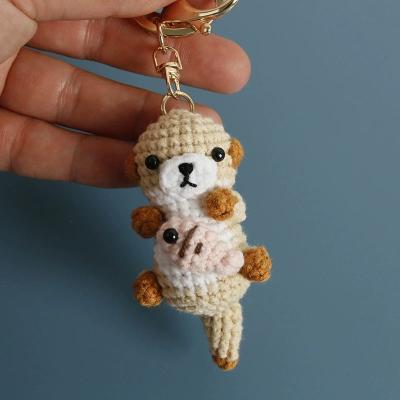 China Knitting Amigurumi Cute Plush Otter Holding Fish Keychain Oyuncak Crochet Animal Toys Doll Soft Crocheted Otter Keychains for sale
