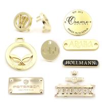 China Custom 38mm Gold Metal Logo Tag Round Bag Charm with Black Oil Text for Brand Name Tags for sale