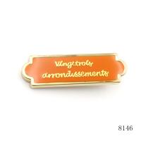 China Gold Plated Zinc Alloy Orange Enamel Metal Tag 40mm x 12mm Custom Logo Plate with Iron Prong Feet for sale
