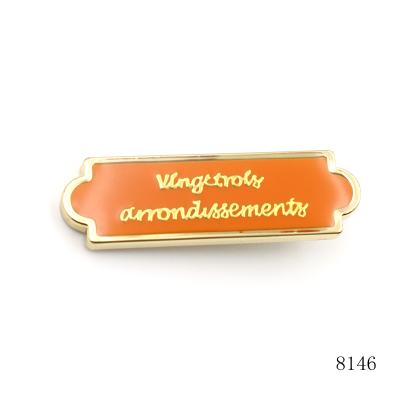 China Gold Plated Zinc Alloy Orange Enamel Metal Tag 40mm x 12mm Custom Logo Plate with Iron Prong Feet for sale
