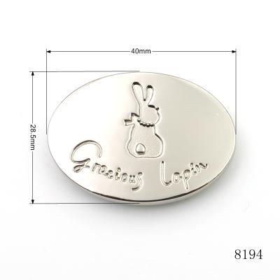 China Custom Engraved Oval Metal Logo Plate 40mm x 28.5mm Shiny Silver Plating for Bags for sale