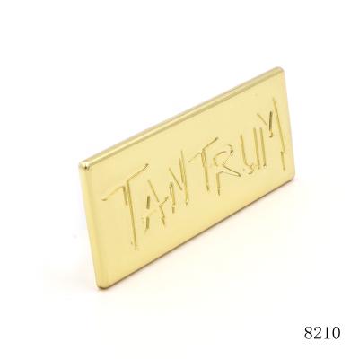 China Custom Gold Metal Logo Plate 65x24mm Engraved Brand Name Plate for Handbags for sale