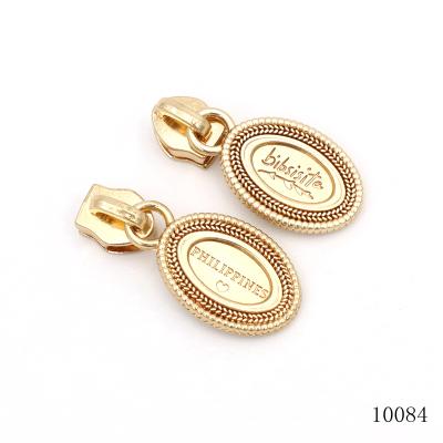 China Custom Engraved Logo Metal Zipper Puller, Gold Oval Embossed Decorative Zipper Pull Tab, Premium Metal Zipper Slider Hardware Accessories for Handbags, Purses & Luggage for sale