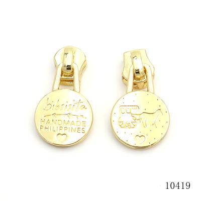 China Custom Engraved Round Metal Zipper Pull Gold Plated Handbag Zipper Charm for sale