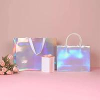 China Custom Holographic Glitter Silver Foil Clothing Carrier Bags 300gsm Paper Shopping Bags for sale