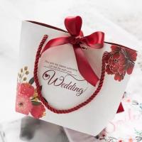China Custom Logo Printed Paper Carrier Bags Luxury Wedding Gift Bags with Ribbon Closure 300gsm for sale