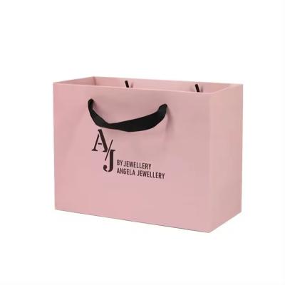 China Custom Luxury Gift Garment Paper Shopping Bags With Logo Print Newest Fashinable for sale