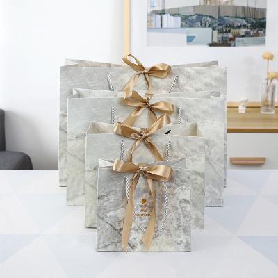 China Customized Color Cardboard Shopping Paper Bags With Ribbon Handle For Clothing Shoes for sale