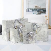 China Customized Color Cardboard Shopping Paper Bags With Ribbon Handle For Clothing Shoes for sale