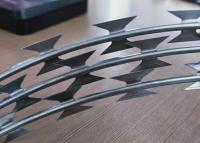 China Hot Dipped Galvanized Razor Barbed Wire BTO 22 450mm Coil 0.8mm thickness for sale
