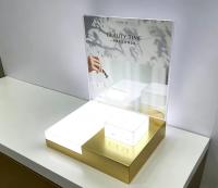 China L-shaped product display stand, transparent acrylic cosmetic display rack with lights, skin care product shelf for sale