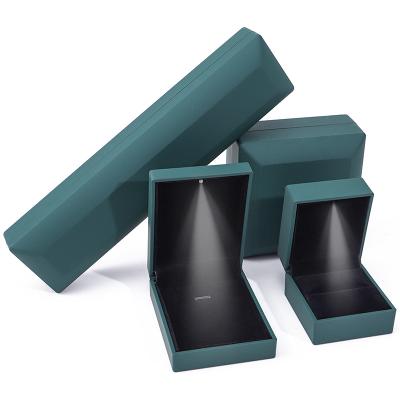 China Custom Logo Green LED Light Velvet Jewelry Box for Rings Bracelets Necklaces 300000pcs Monthly for sale