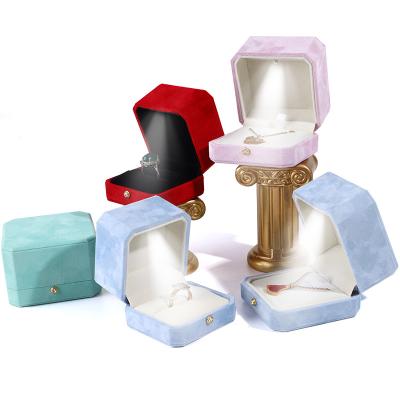 China Blue Octagonal Flannel Jewelry Box with Gold Buckle Custom Logo LED Ring Box for sale