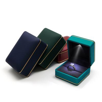 China Custom Logo Silk Screen Dark Green LED Jewelry Box for Luxury Rings Plastic Velvet for sale