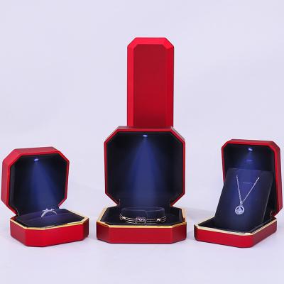 China Customizable Handmade Red Octagon LED Light Jewelry Box with Gold Trim 20cm for sale