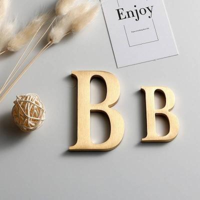 China Golden Brushed Stainless Steel Self-Adhesive Metal Letter Signs 20-30g for Indoor Outdoor Commercial Use for sale