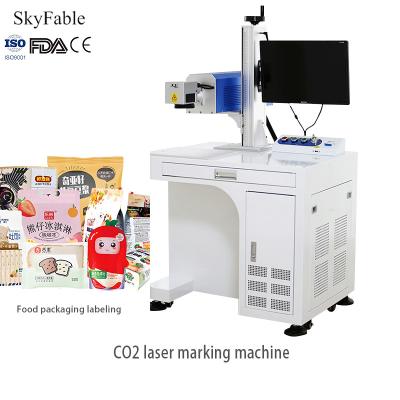 China High Speed CO2 Laser Marking Machine For Food Packaging Date And Batch Number Engraving for sale