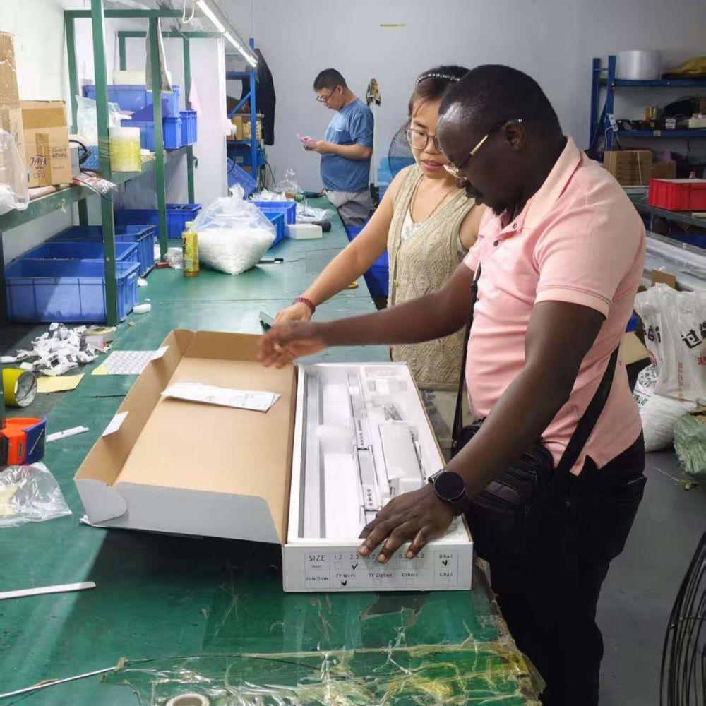 International buyers inspecting Galime's smart motorized shading hardware at our Shenzhen manufacturing center