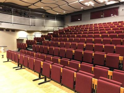 China Riser Mounted Retractable Bleacher Seating Theaters Chair With Red Fabric Upholstery for sale
