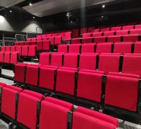 China Indoor Retractable Auditorium Seating Tribune Fabric Upholstered Folding Chair for sale