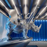 China Metallic Rhino Sculpture with Travel Luggage Set-Artistic Resin Statue for Modern Interior Office Cemetery Decor for sale