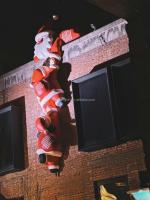 China AMIG 3D FRP Santa Claus Climbing Sculpture Silk Screen Printed Christmas Decoration for Building Facade and Mall Exteriors for sale