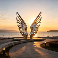 China 304 Stainless Steel Angel Wings Sculpture with Mirror Polished Finish and Hollow Feather Structure for sale