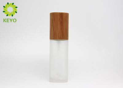 China Skin Care Round Frosted Glass Empty Cosmetic Bottles With Bamboo Cap In 50ml for sale
